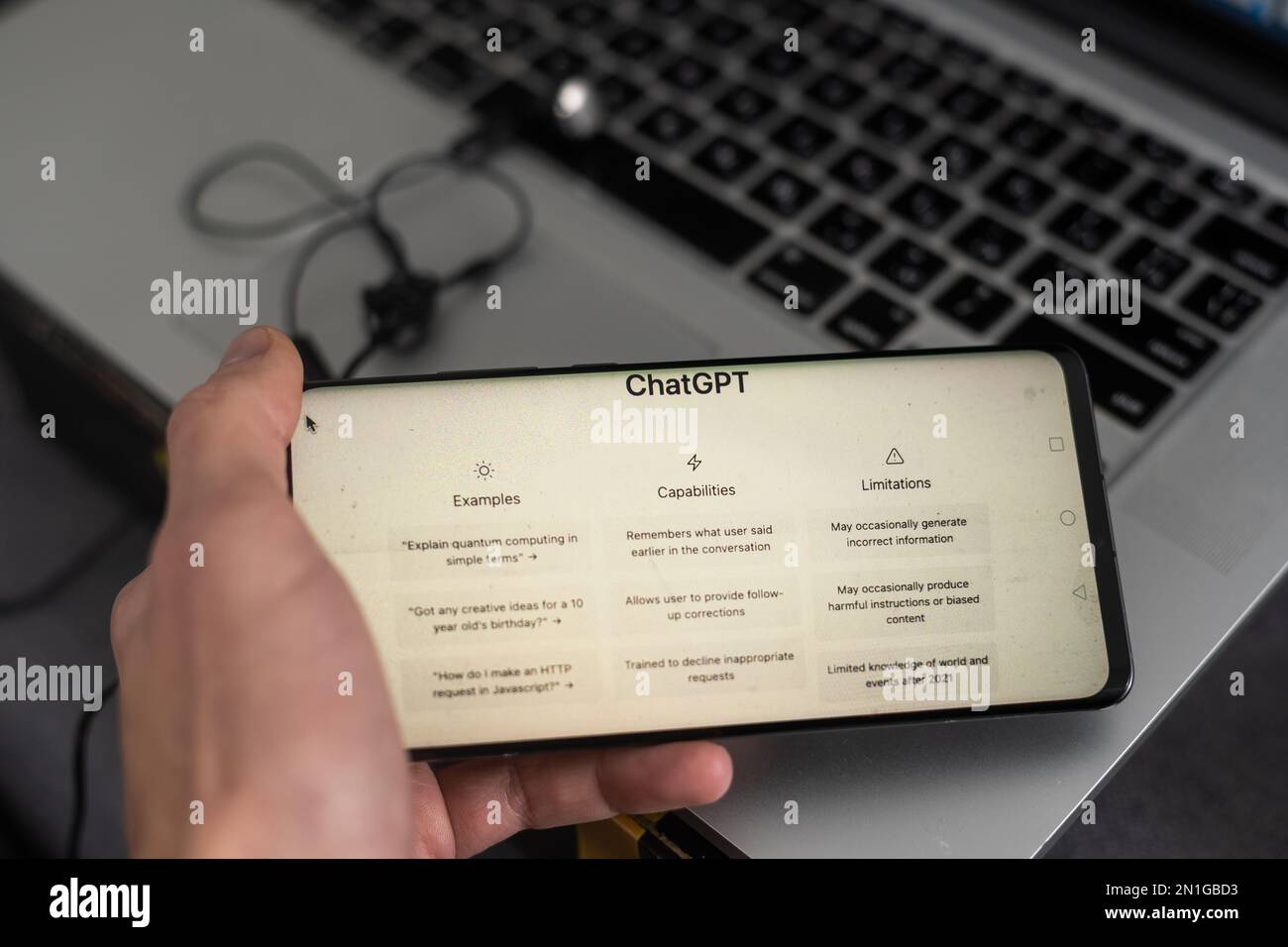 Screen with ChatGPT chat with AI or artificial intelligence. Man search for information using ...