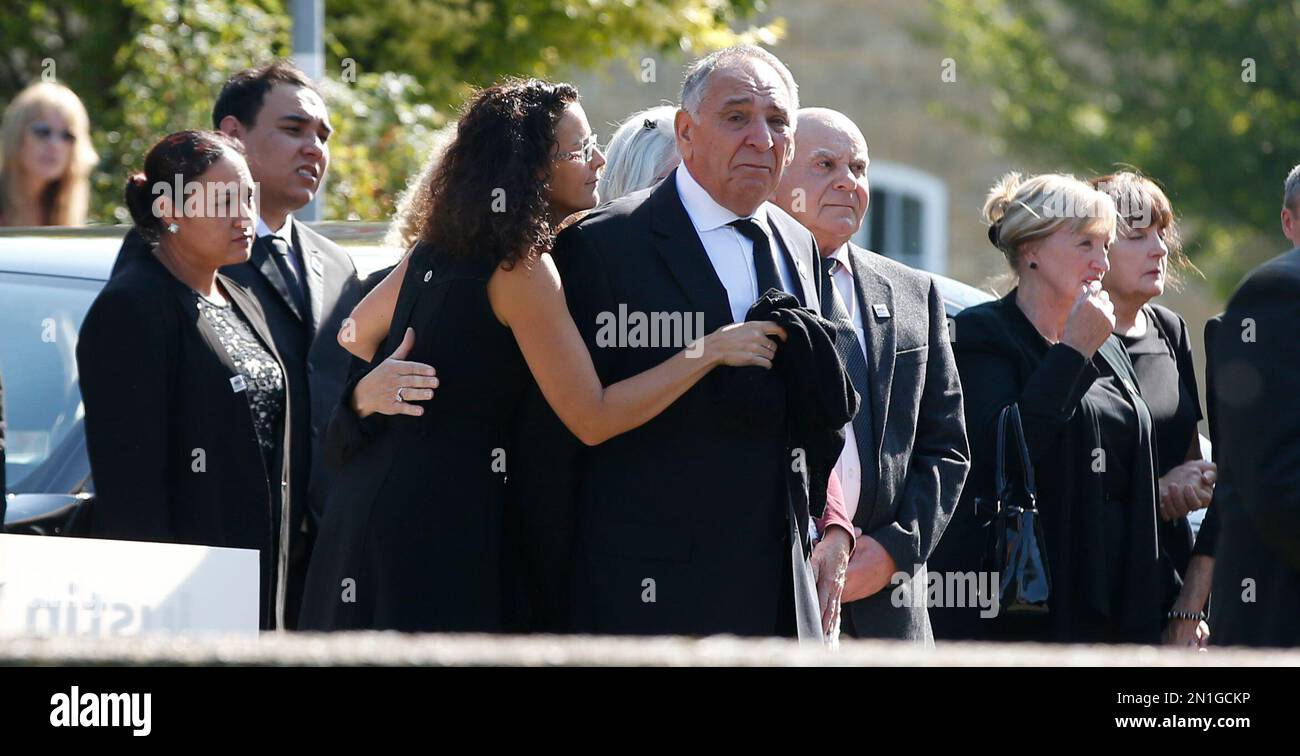 Justin Wilson's wife Julia, and his father Keith embrace as they arrive ...