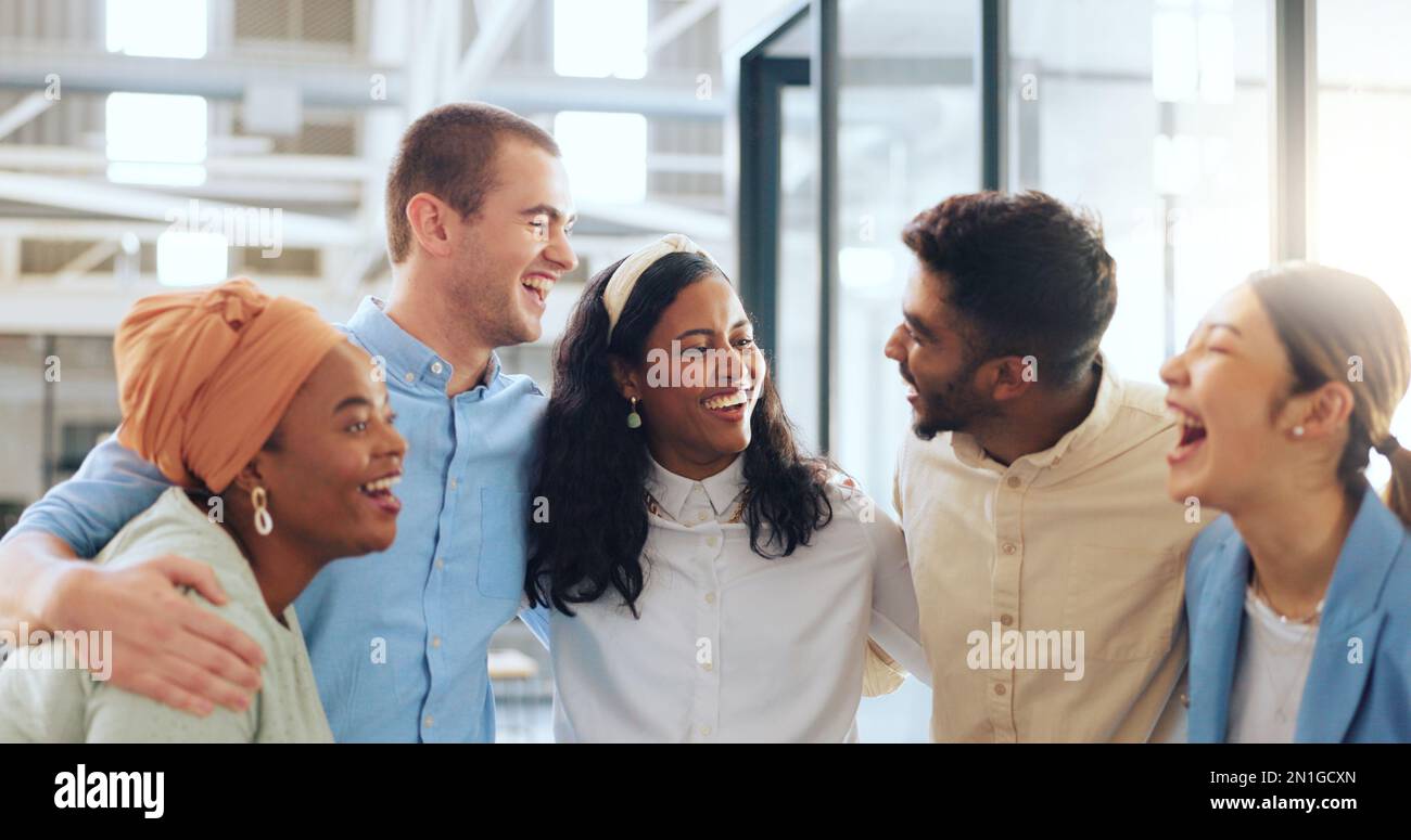 Office, diversity and business people hug for team building, teamwork and collaboration. Happy ...