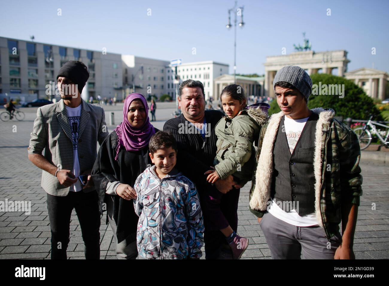 Laith Majid, a refugee from Iraq, center, holds his daughter Nour on ...