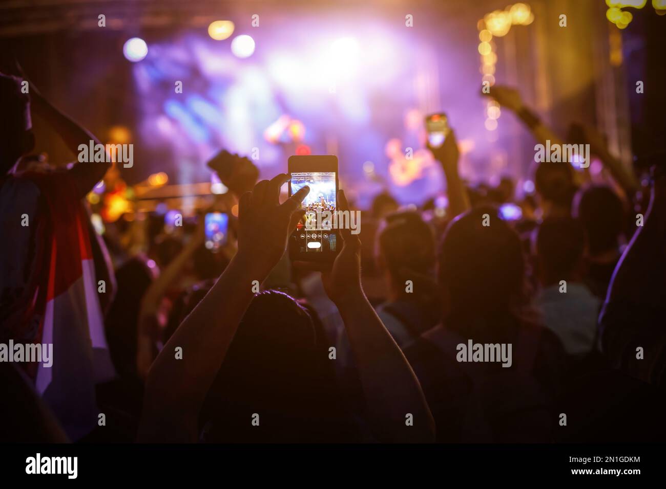 Large group of happy people enjoying rock concert Stock Photo - Alamy