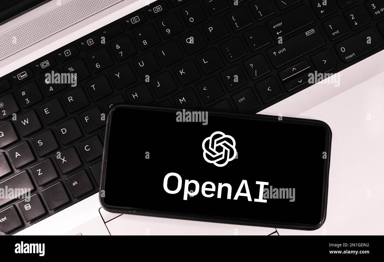 Open Ai inside mobile screen with laptop in the backdrop, futuristic ...