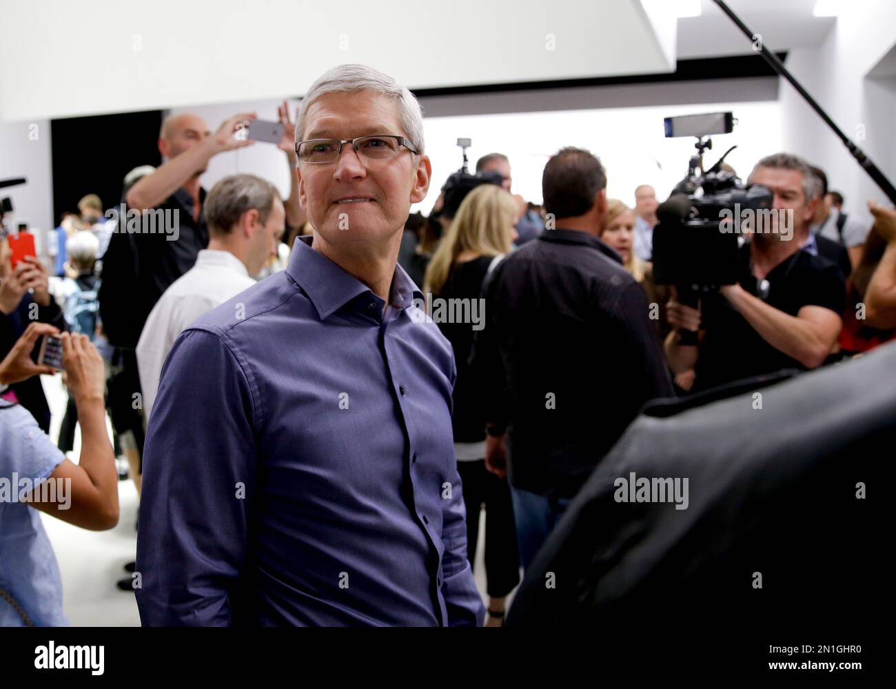 Apple CEO Tim Cook, center, walks through the demo room after the Apple ...