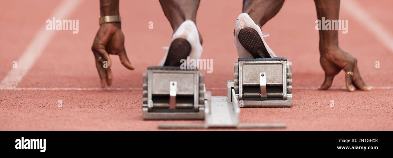 Back view of male feet on starting block ready for a sprint start Stock ...