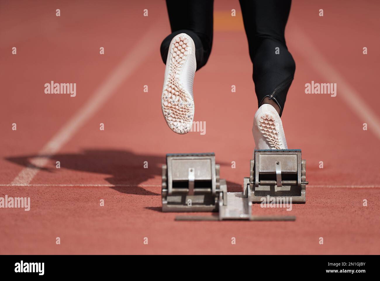 Back view of male feet on starting block ready for a sprint start Stock ...