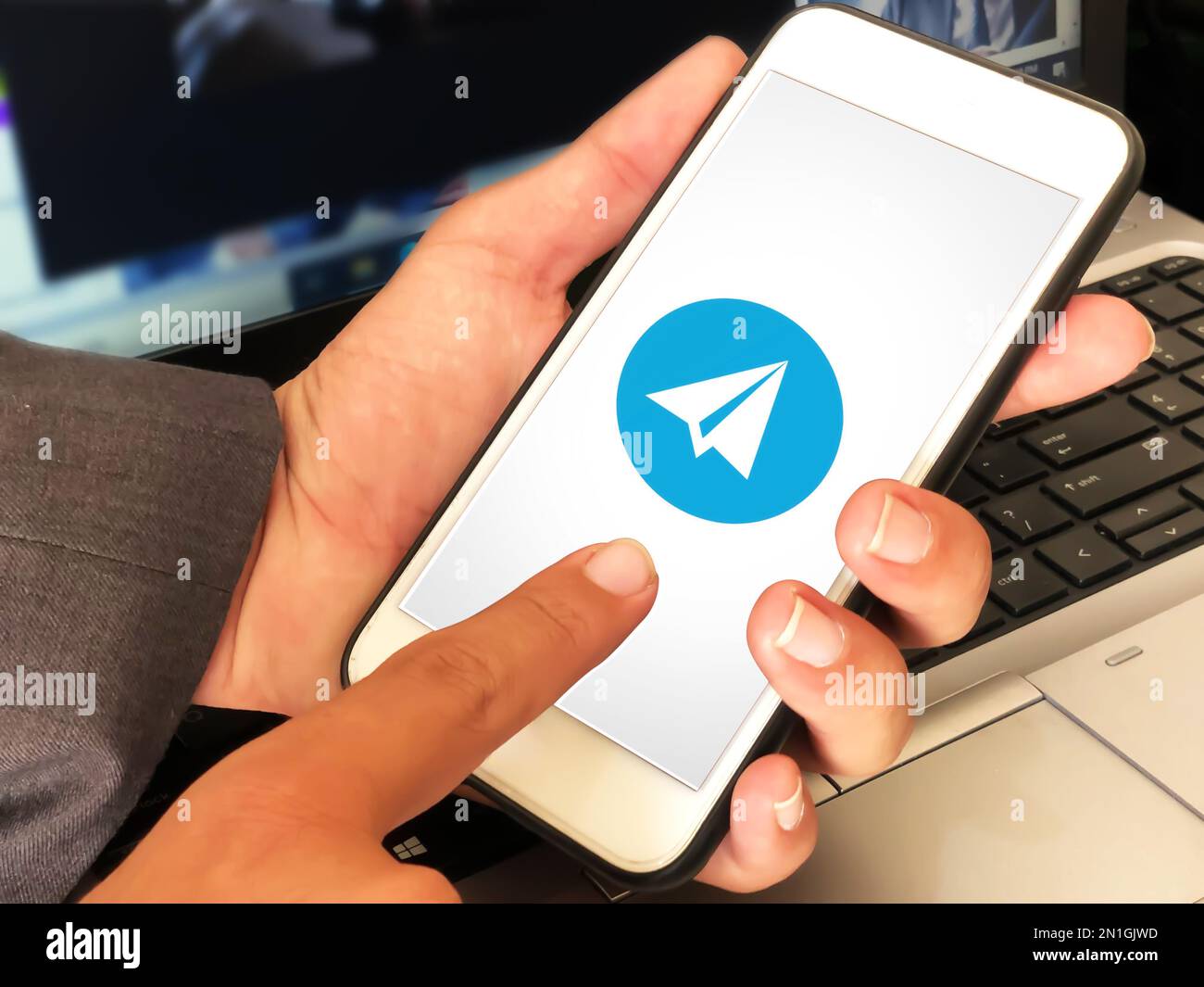 Telegram mobile application being used by man, editorial background ...
