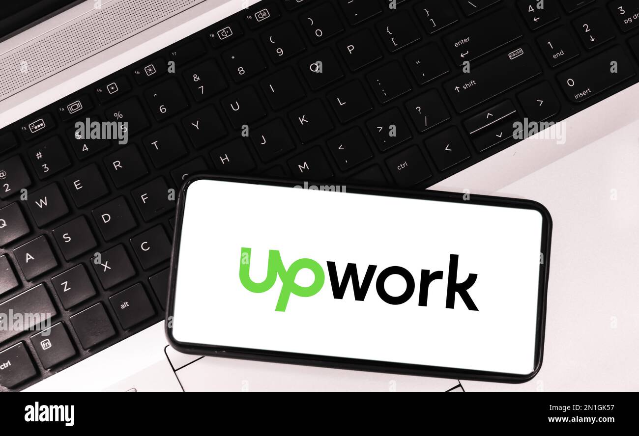 Upwork mobile application concept background with laptop in the background. Editorial ...