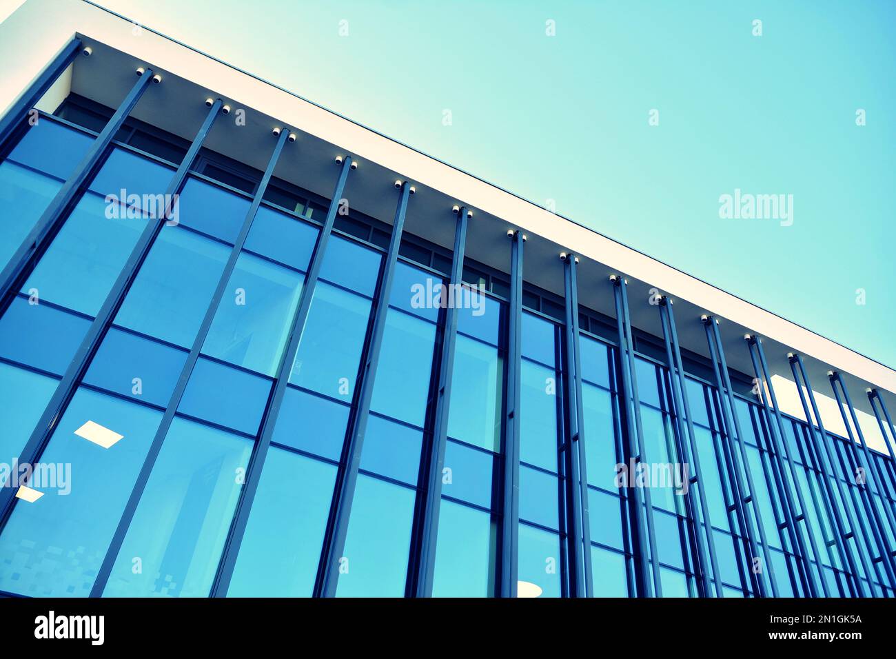Modern office building on a clear sky background. Retro stylized ...
