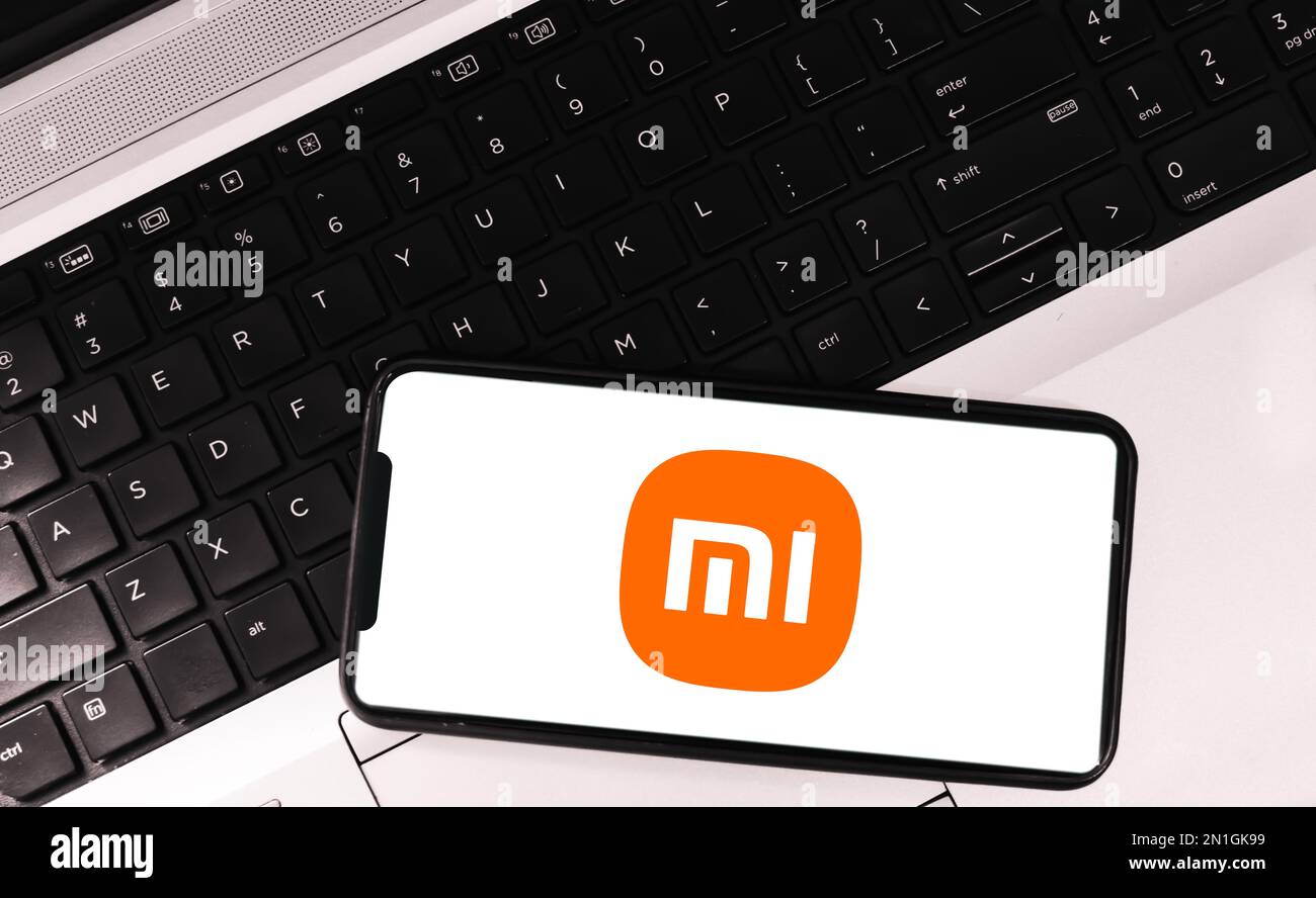 Xiaomi mobile company with screen and laptop in the backdrop, editorial ...