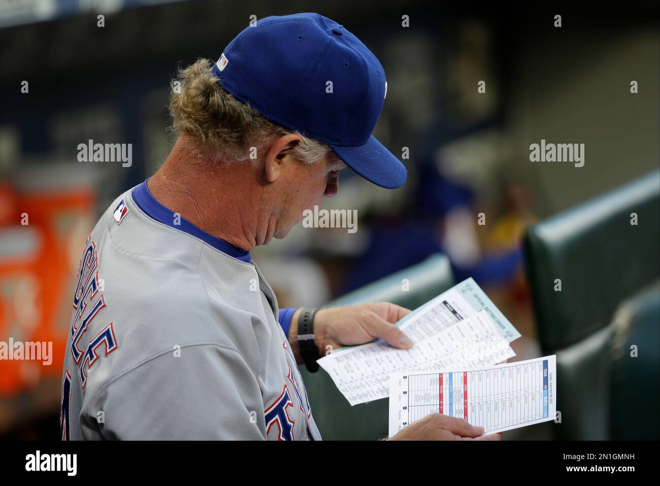 Texas Rangers bench coach Steve Buechele goes over line-up cards before ...