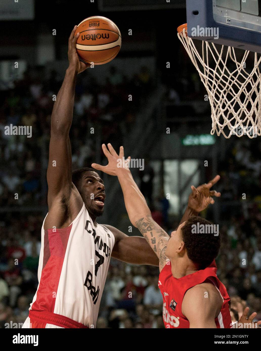 Canada's Andrew Nicholson, left , goes for a shot over Mexico's Juan ...