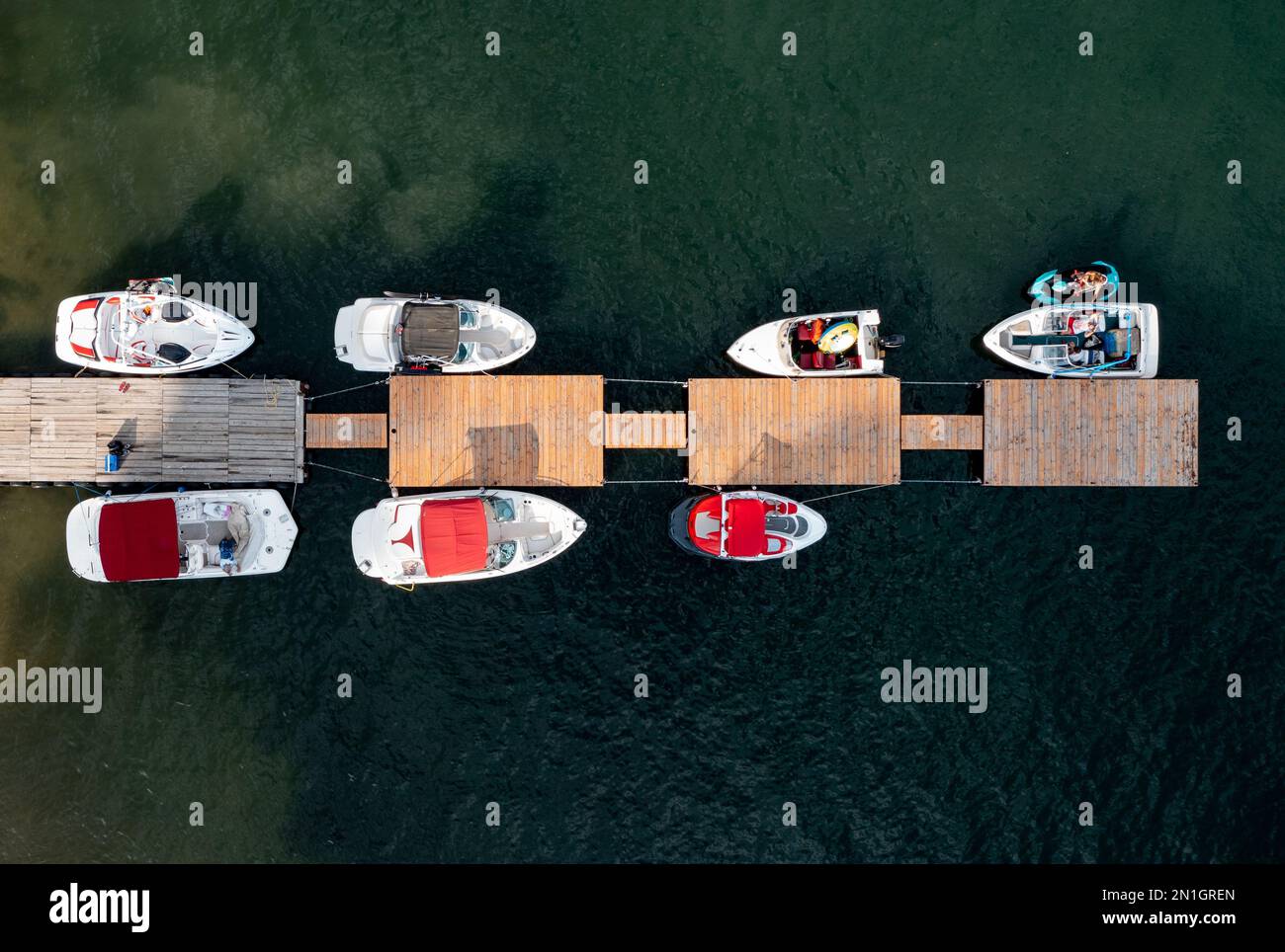 A top view of boats next to the wooden harbor Stock Photo - Alamy