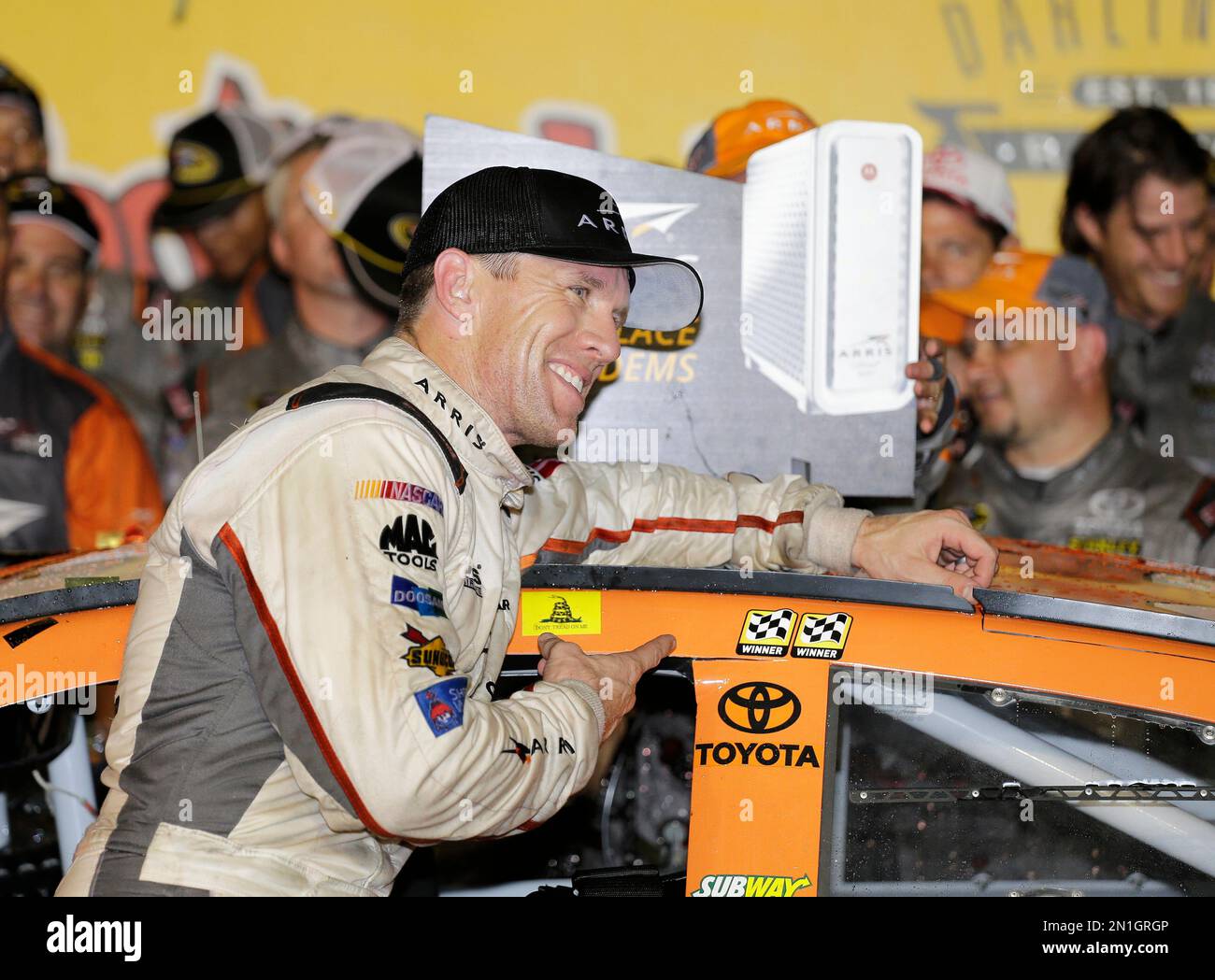 Carl Edwards points at his 2 checkered flag decals after winning a ...