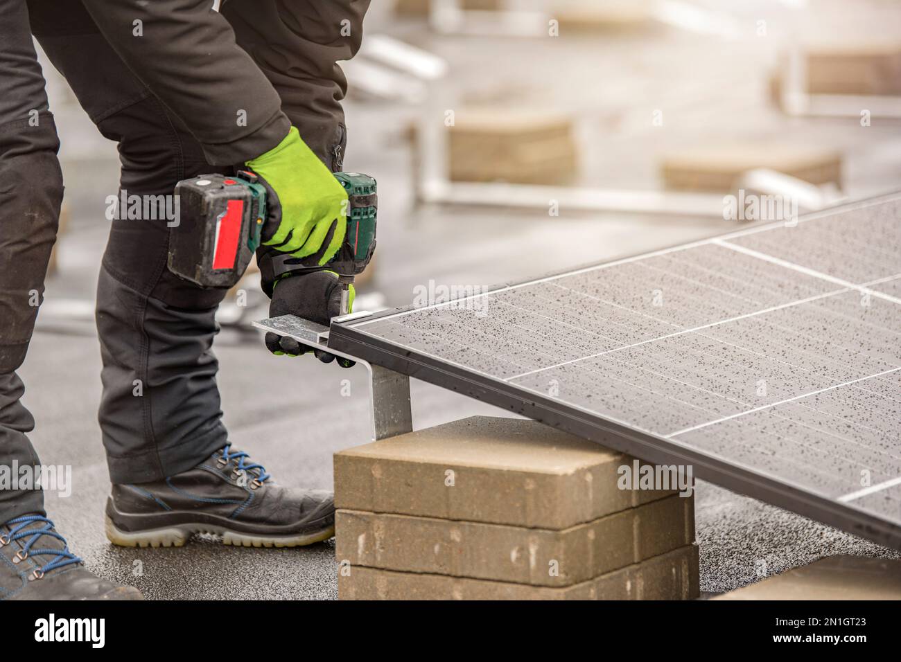 The solar panel installer twists the modules together using aluminum ...