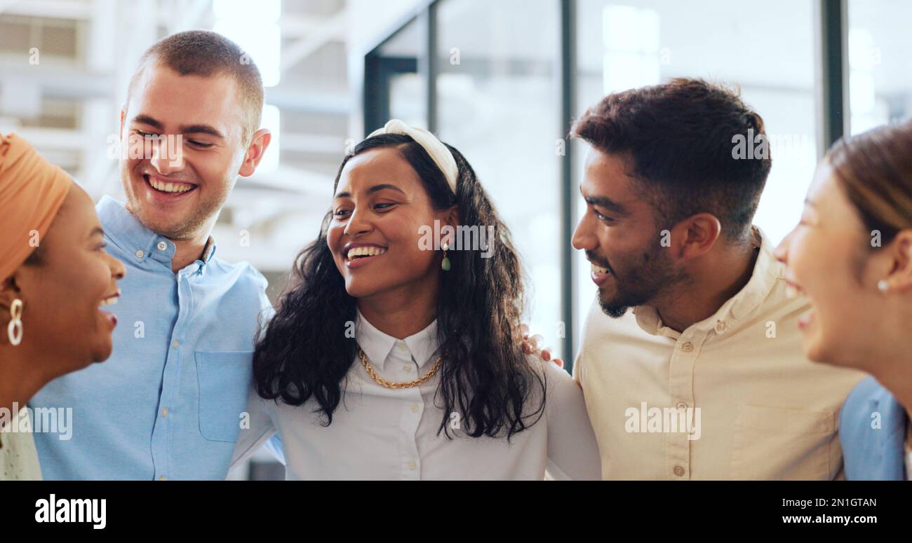 Office, diversity and business people hug for team building, teamwork and collaboration. Happy ...