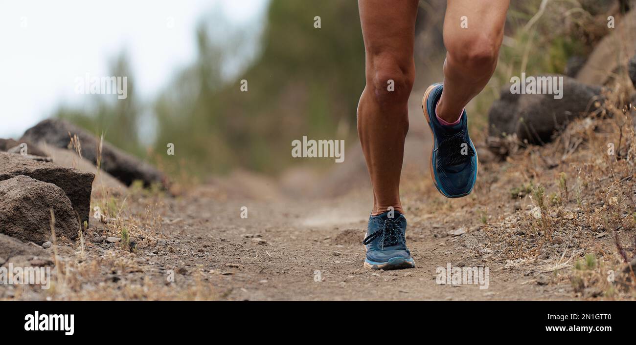 Trail running man on mountain path exercising Stock Photo - Alamy