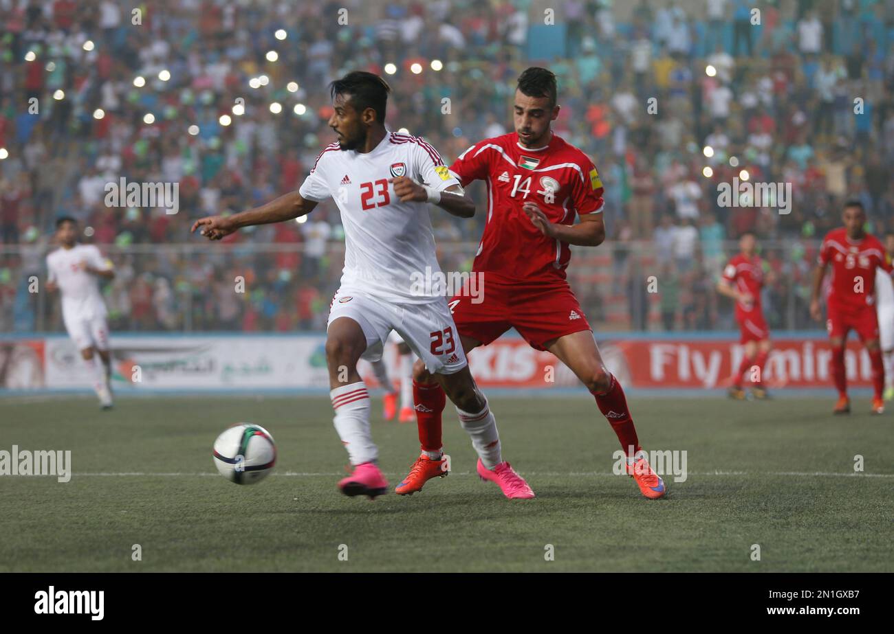 UAE's Mohamed Gharib, left, tries to avoid Palestinian Abdallah Jaber ...