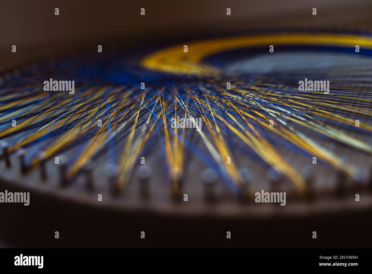 Colored thread mandala on a wooden board with nails. Mandala Moon ...