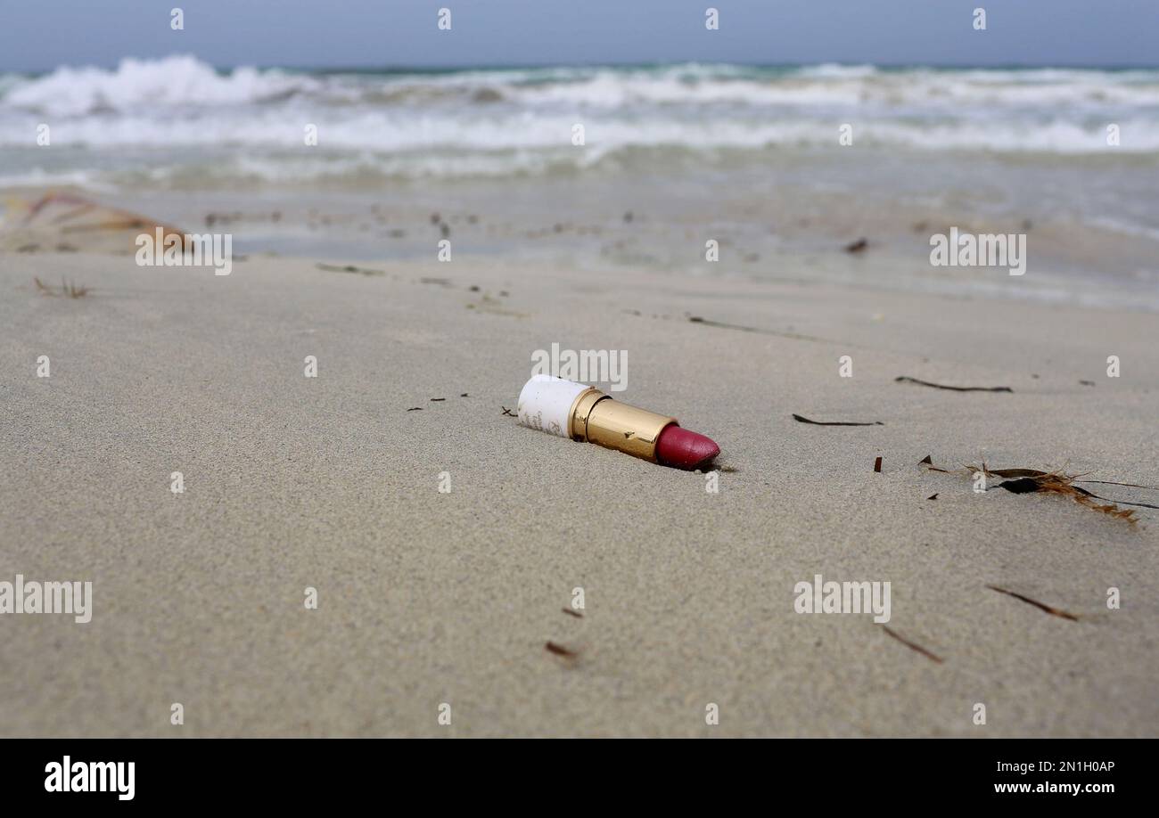 In this Monday, Sept. 7, 2015 photo, a lipstick tube lies on the beach ...