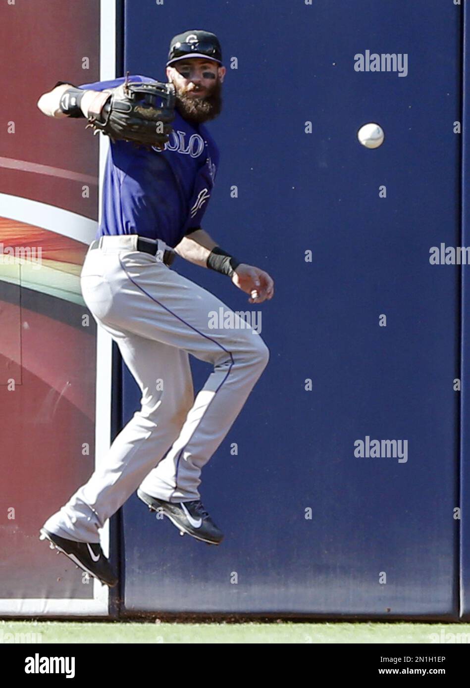 Colorado Rockies center fielder Charlie Blackmon misses the ball coming ...