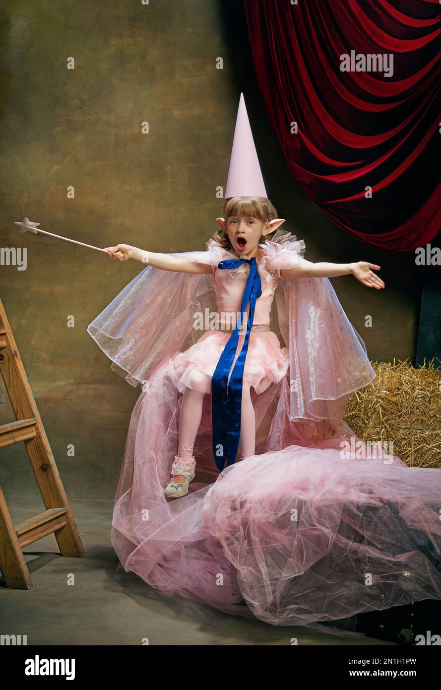 Emotional little kid, beautiful girl in image of fairy magical elf ...