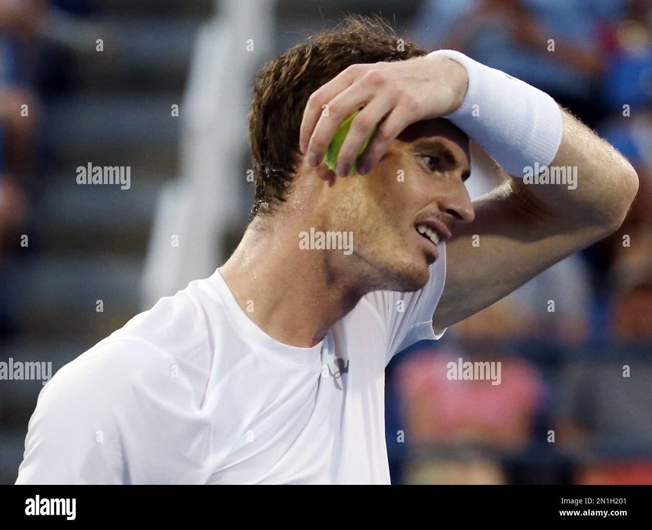 Andy Murray, of the United Kingdom, wipes sweat from his brow before ...