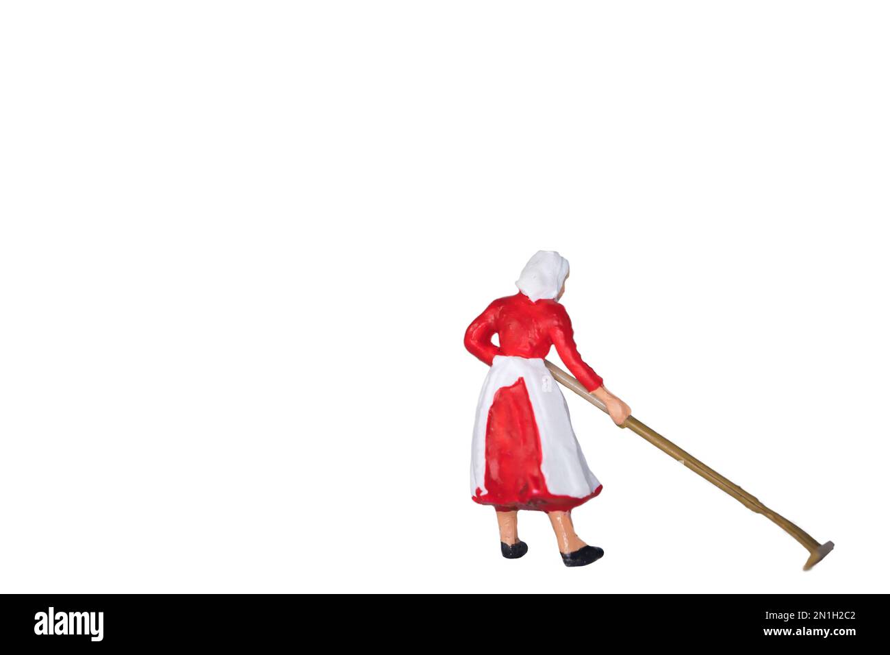 Female farmer at work with a rake isolated on white background ...