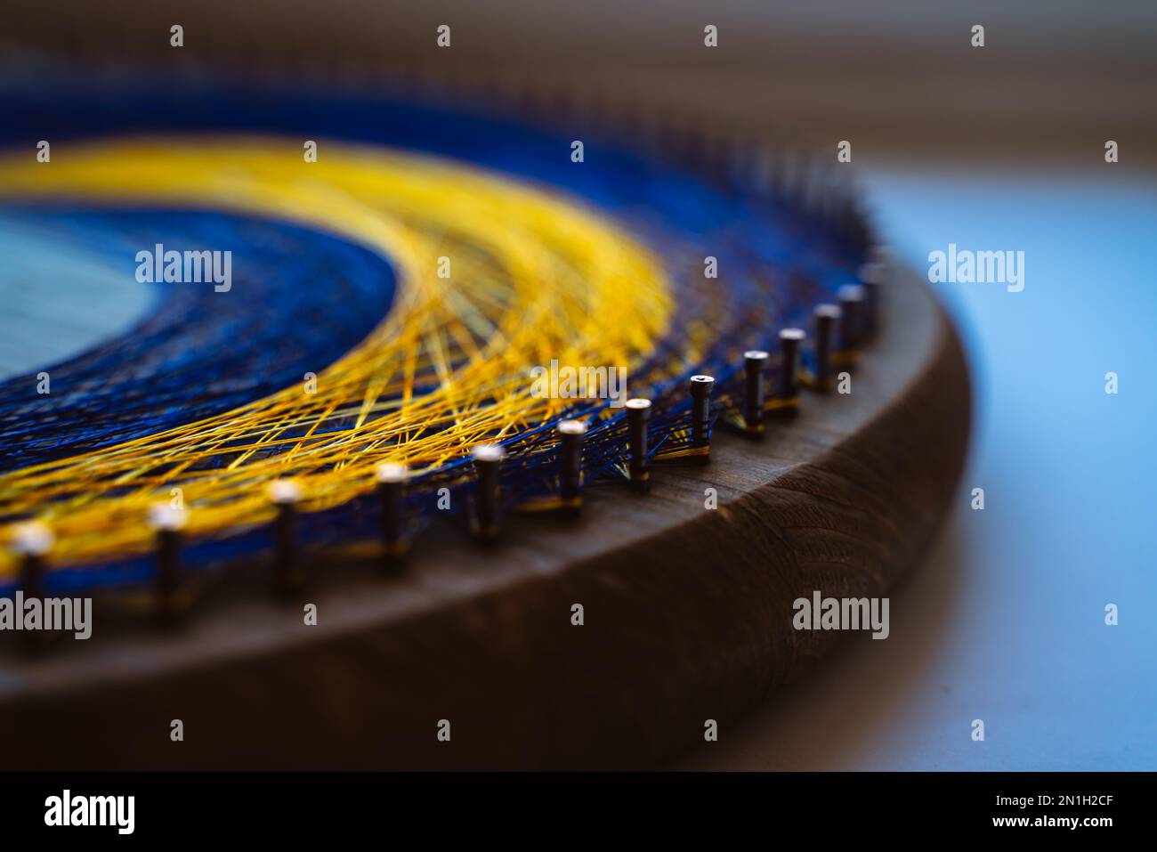 Colored thread mandala on a wooden board with nails. Mandala Moon ...