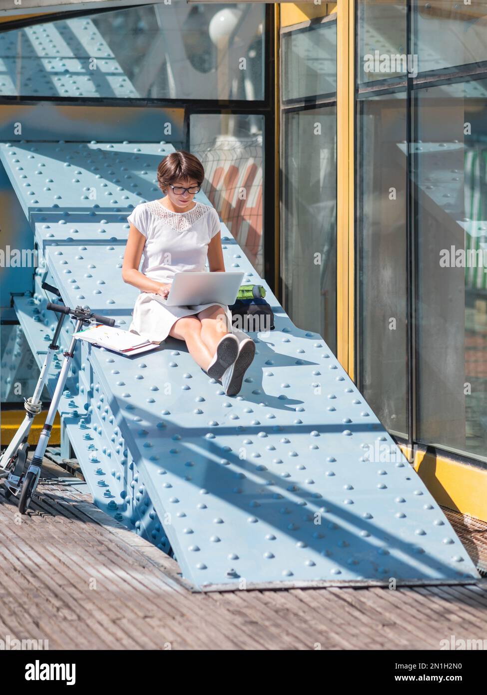 Student is working with laptop and handwritten notes at university ...