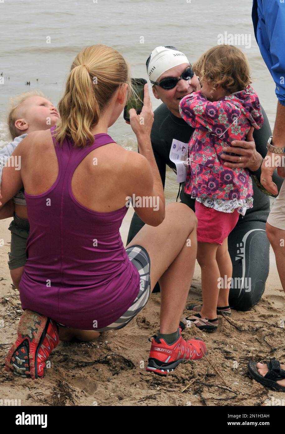 Open Water swimmer Dan Ohm, 43, of Midland, Ga., hugs his daughter ...