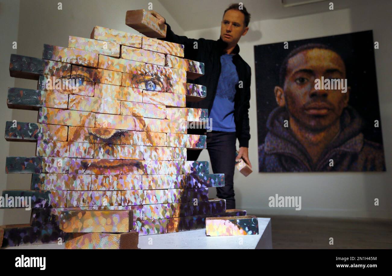 Artist Jimmy C places a final brick on his painting called 'Fragments ...