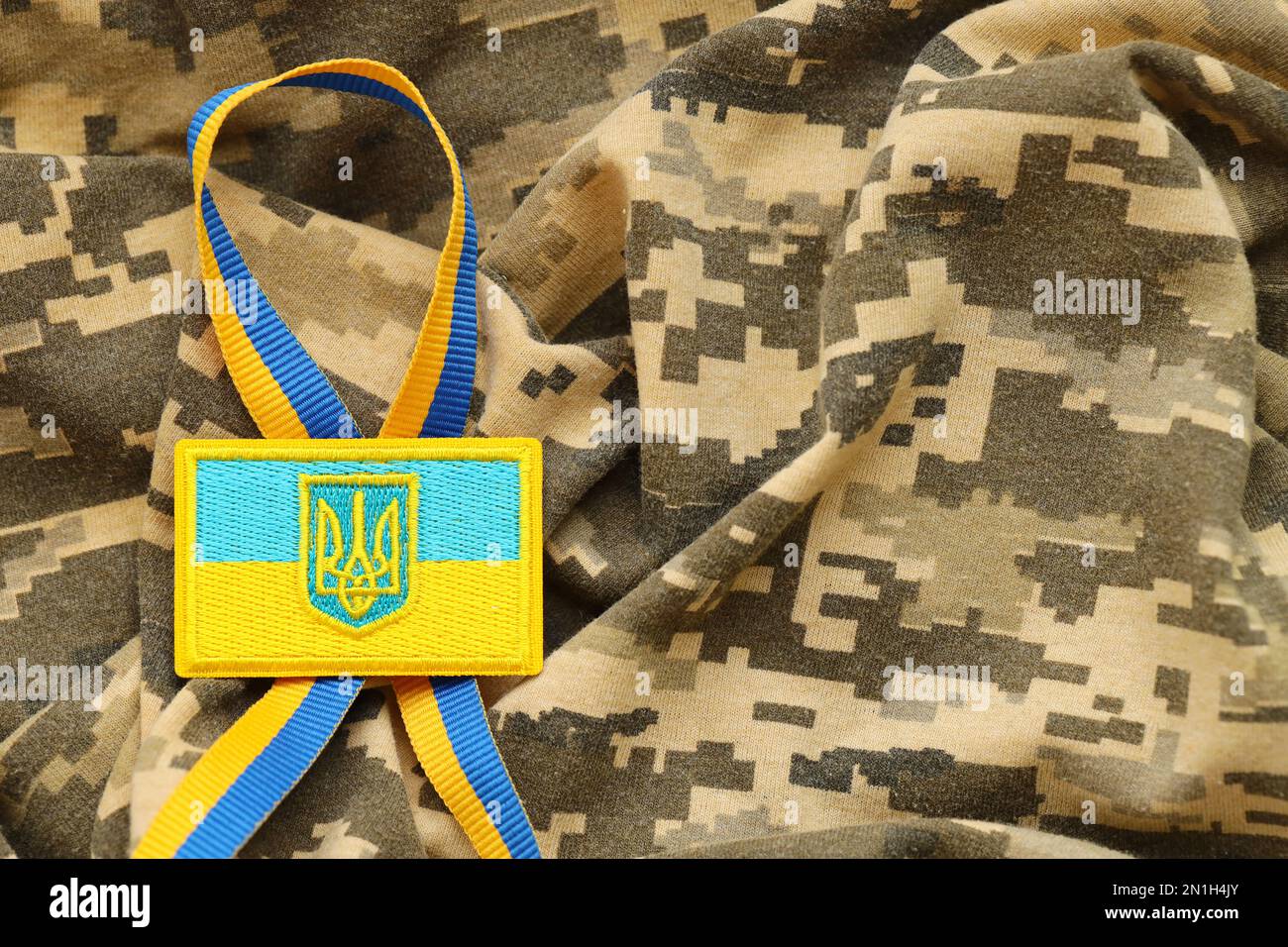 Pixeled digital military camouflage fabric with ukrainian flag and coat ...