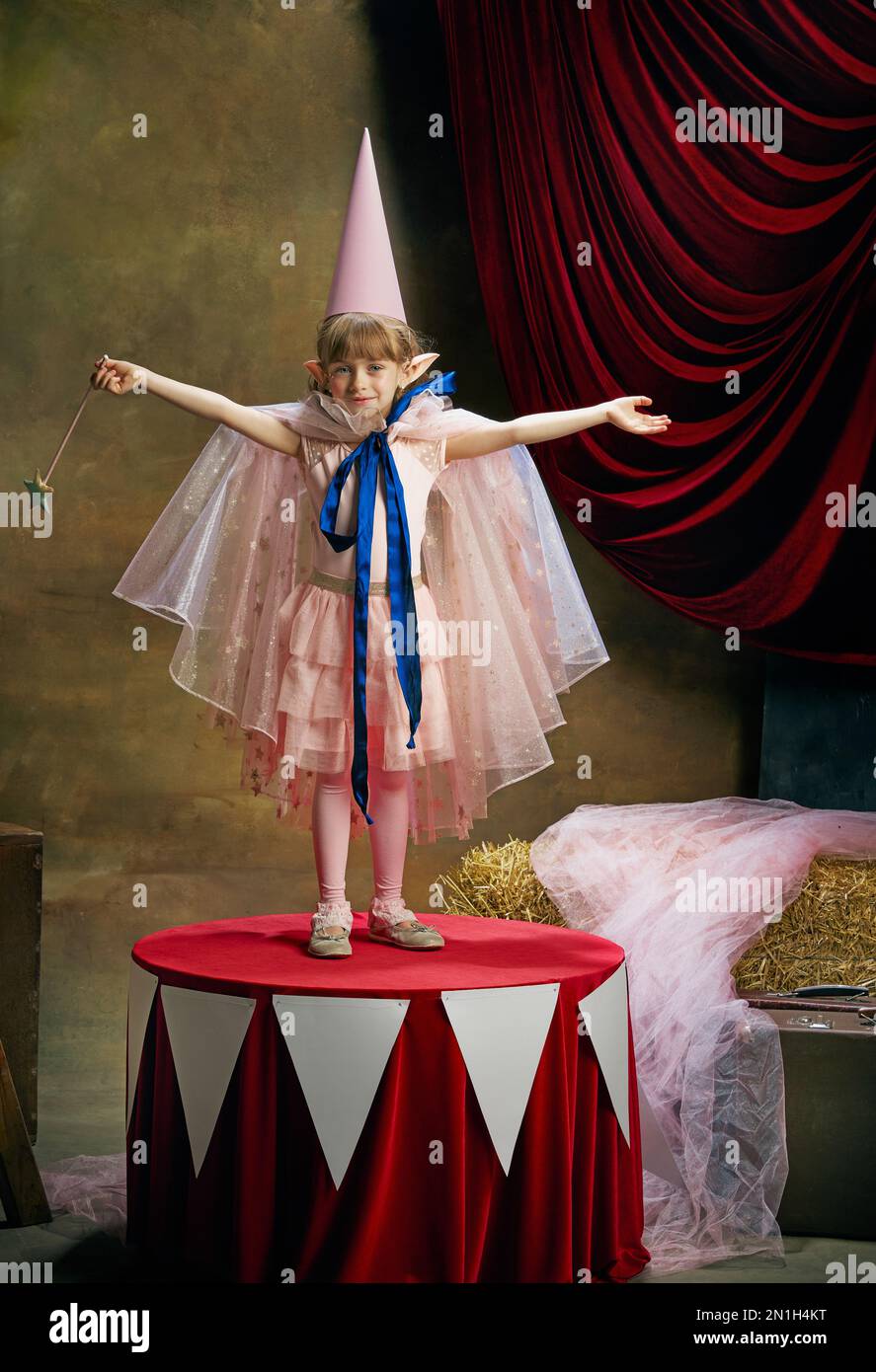 Little performer. Beautiful cute girl, child in image of magical elf ...
