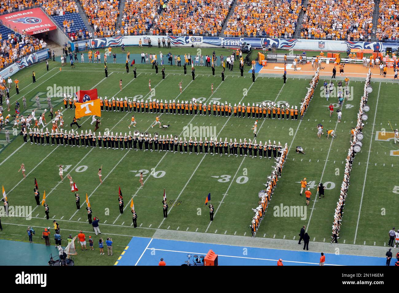 Tennessee players run through a "T" formation made by the marching band ...