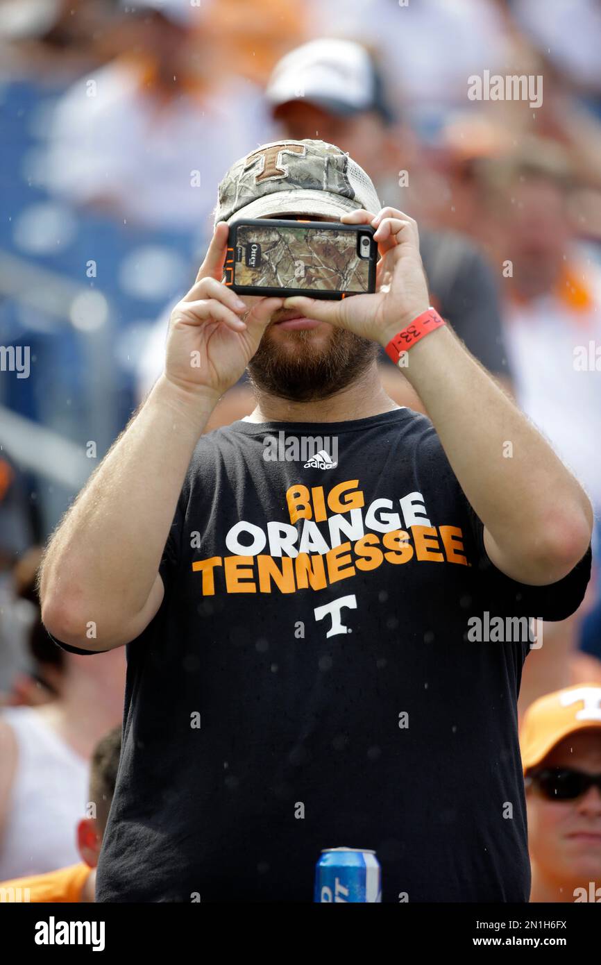 A Tennessee fan takes pictures as players warm up before an NCAA ...