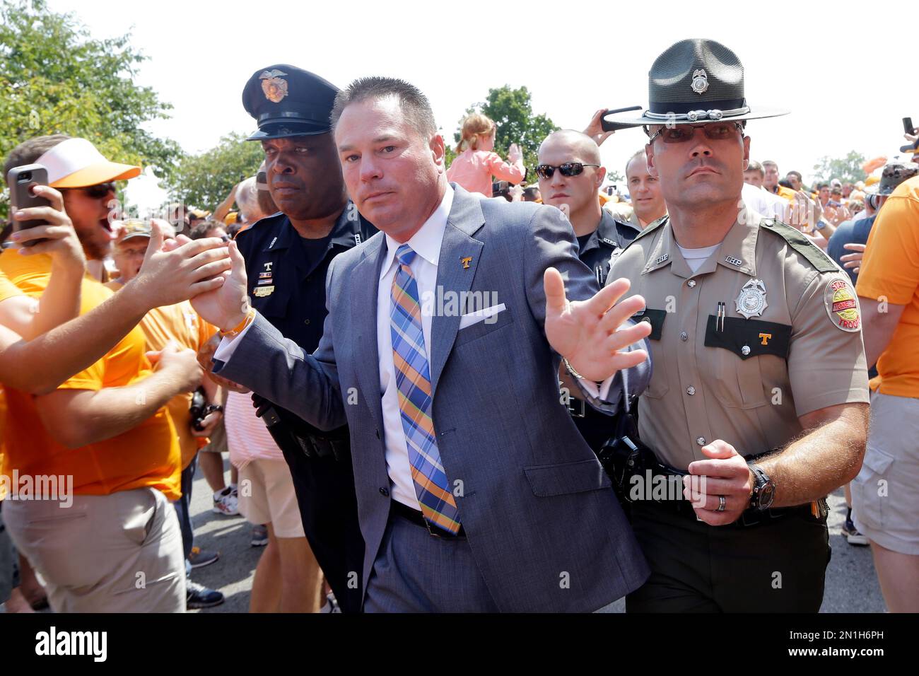 Tennessee head coach Butch Jones is greeted by fans as he arrives for ...