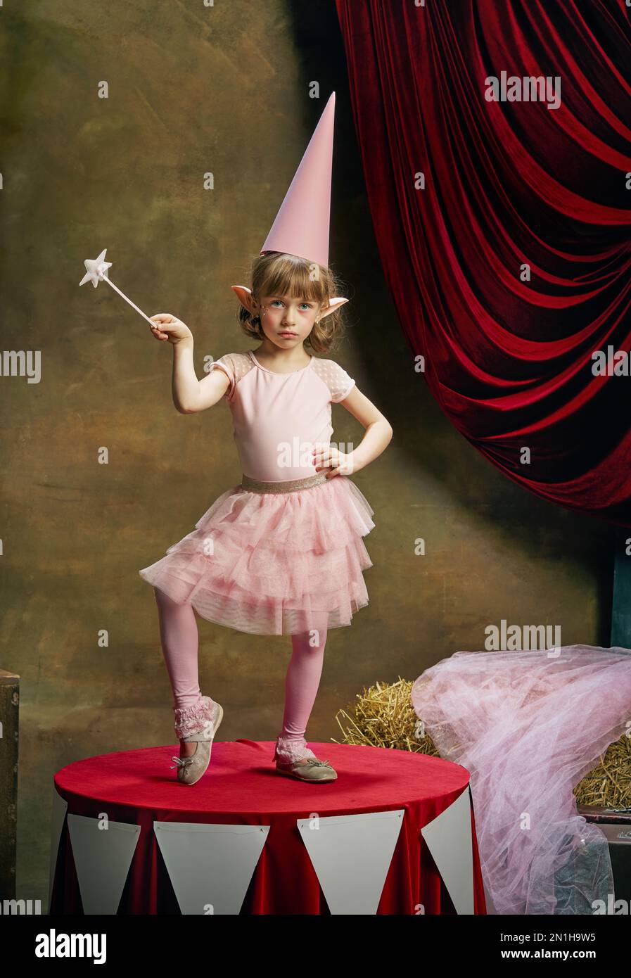 Magic. Little cute girl, kid in image of magical elf posing in pink ...