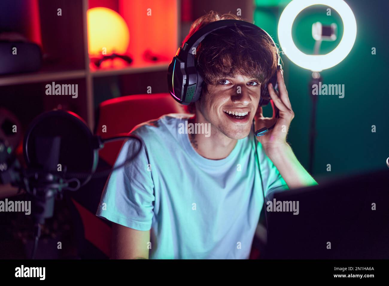 Young blond man playing video game using computer at gaming room Stock ...