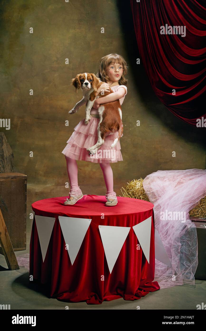 Magic. Little cute girl, kid in image of magical elf posing with dog ...