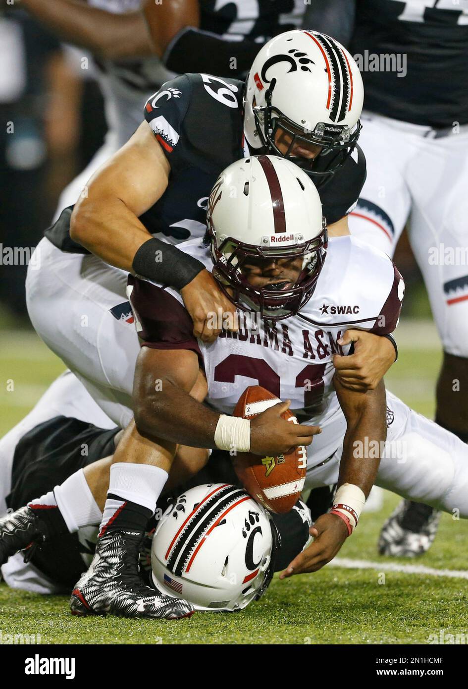 Alabama A&M running back Byran Brower (31) is tackled by Cincinnati ...