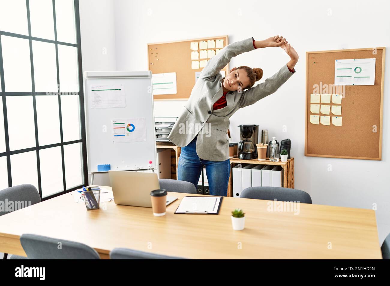 Young woman business worker stretching at office Stock Photo - Alamy