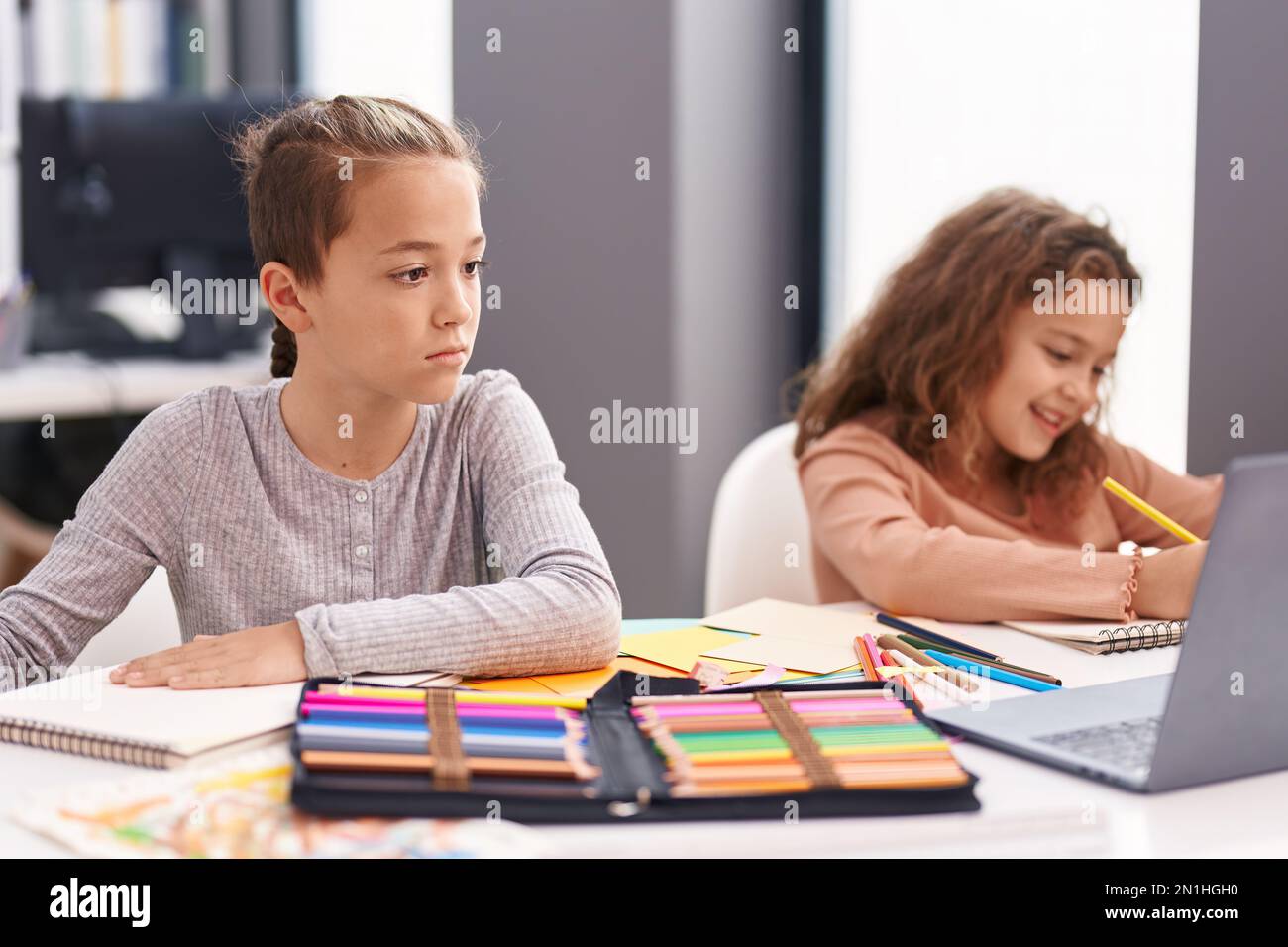 Two kids students using computer studying at classroom Stock Photo - Alamy