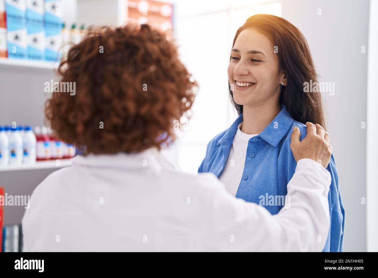 Two women pharmacist and customer speaking at pharmacy Stock Photo - Alamy