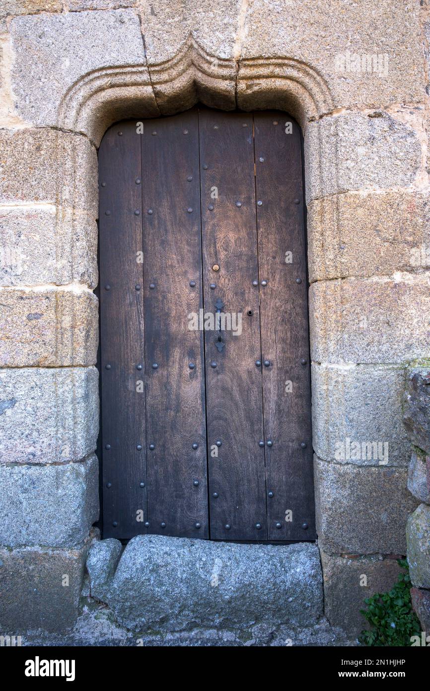 Wooden door with stone Mudejar arch bell tower of Santa Maria church in ...