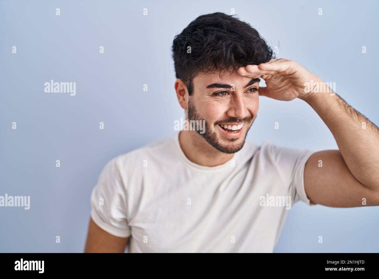 Hispanic man with beard standing over white background very happy and ...