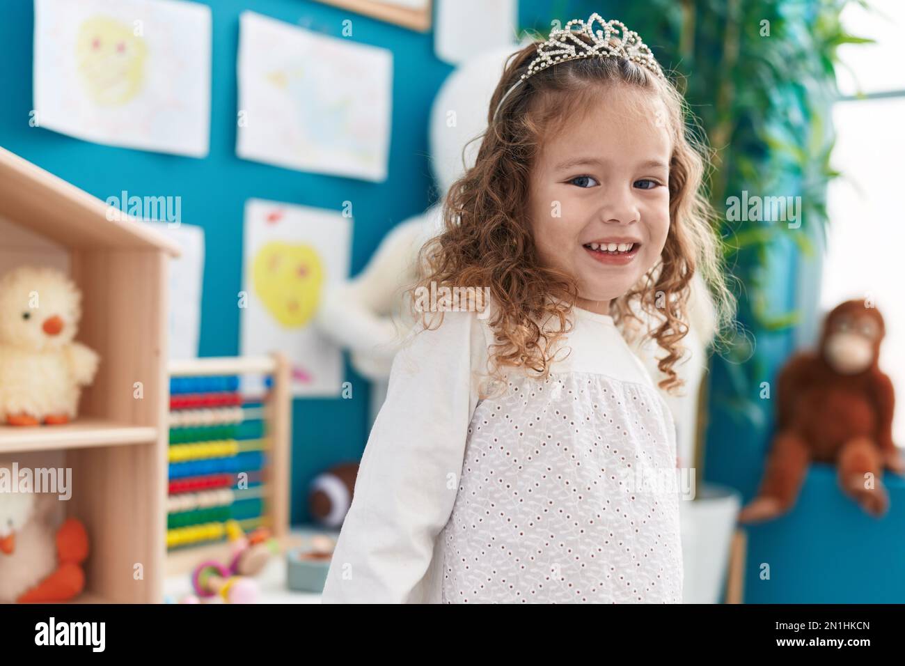 Adorable blonde toddler smiling confident wearing princess crown at kindergarten Stock Photo - Alamy
