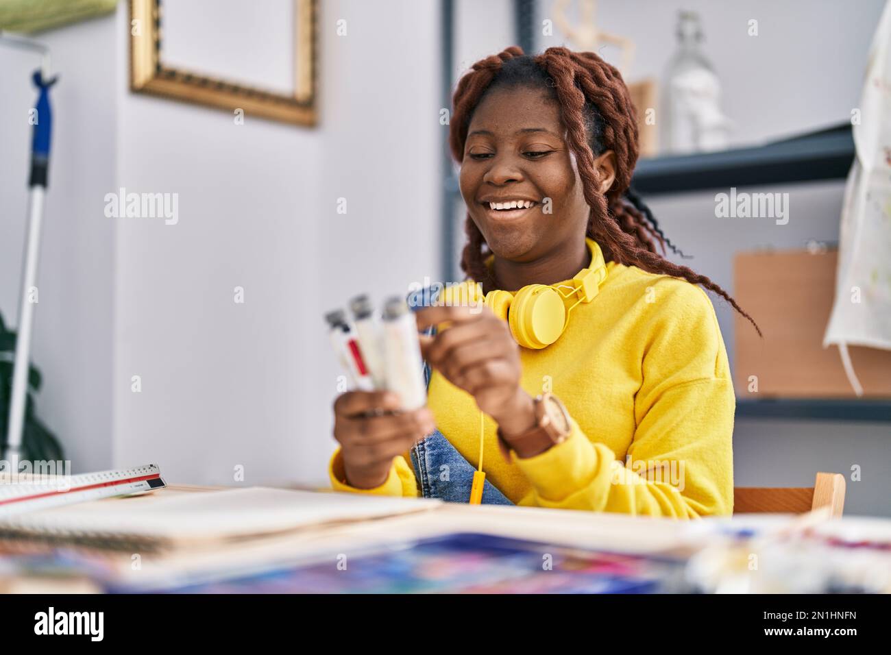 African american woman artist smiling confident choosing color at art ...