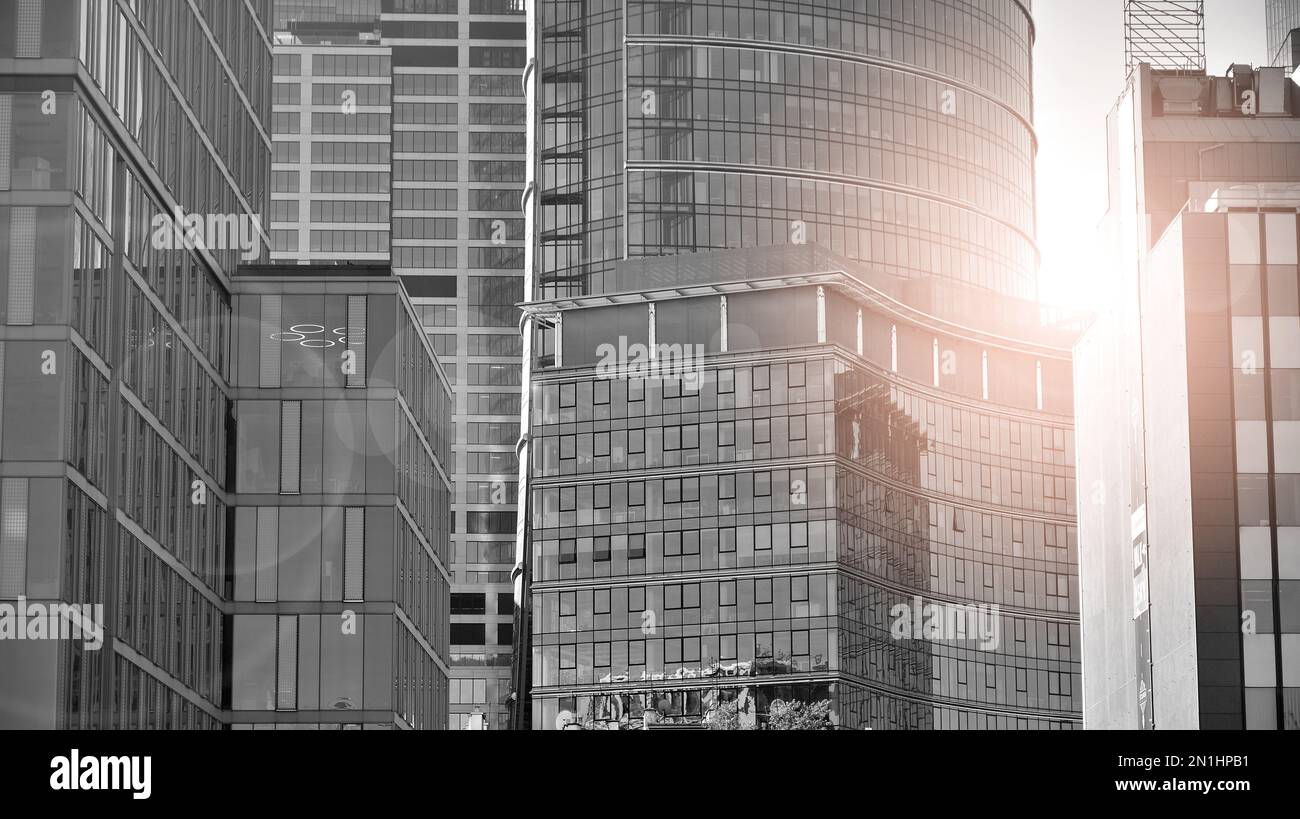 Bottom view of modern skyscraper in business district against blue sky ...