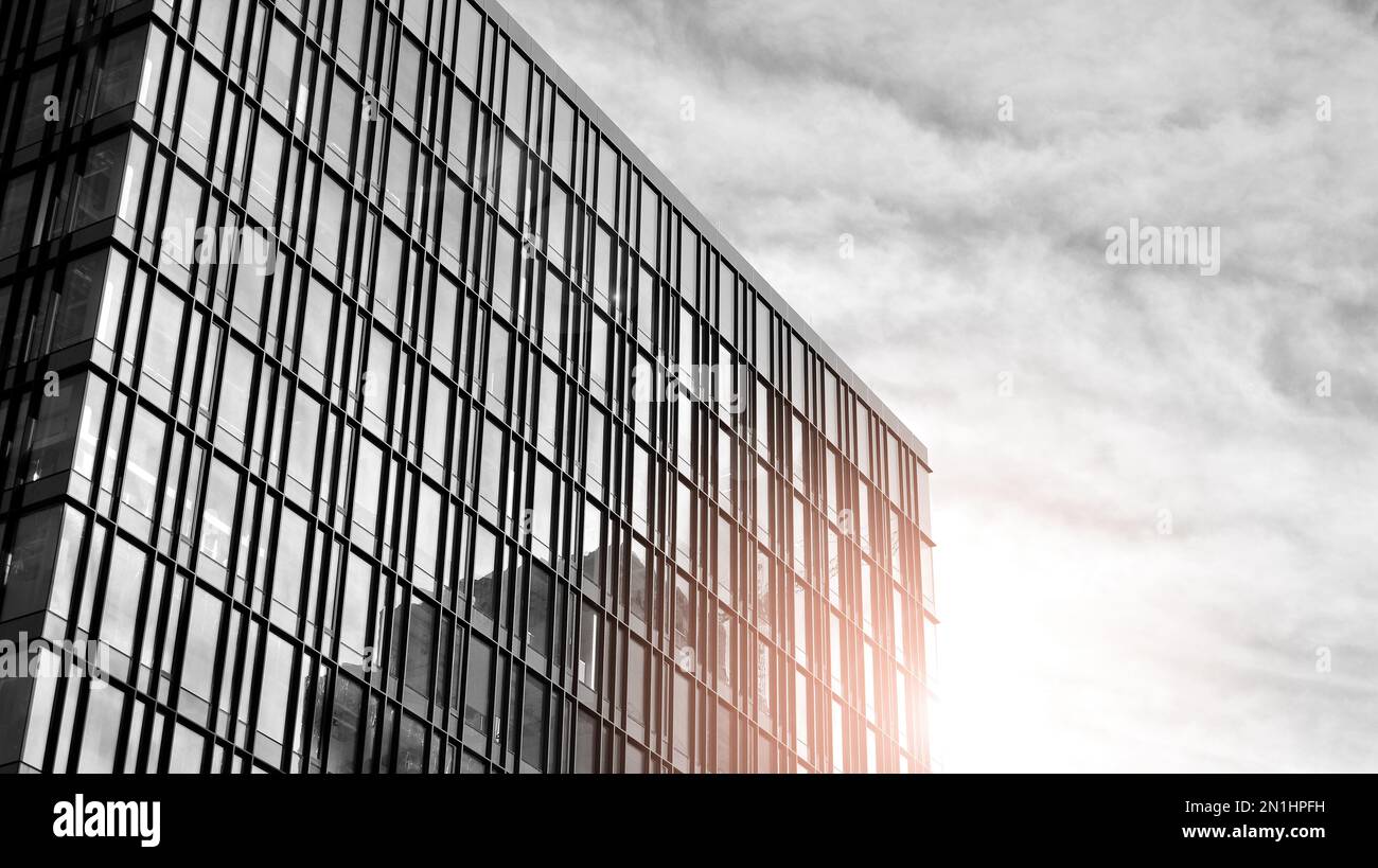Bottom view of modern skyscraper in business district against blue sky ...