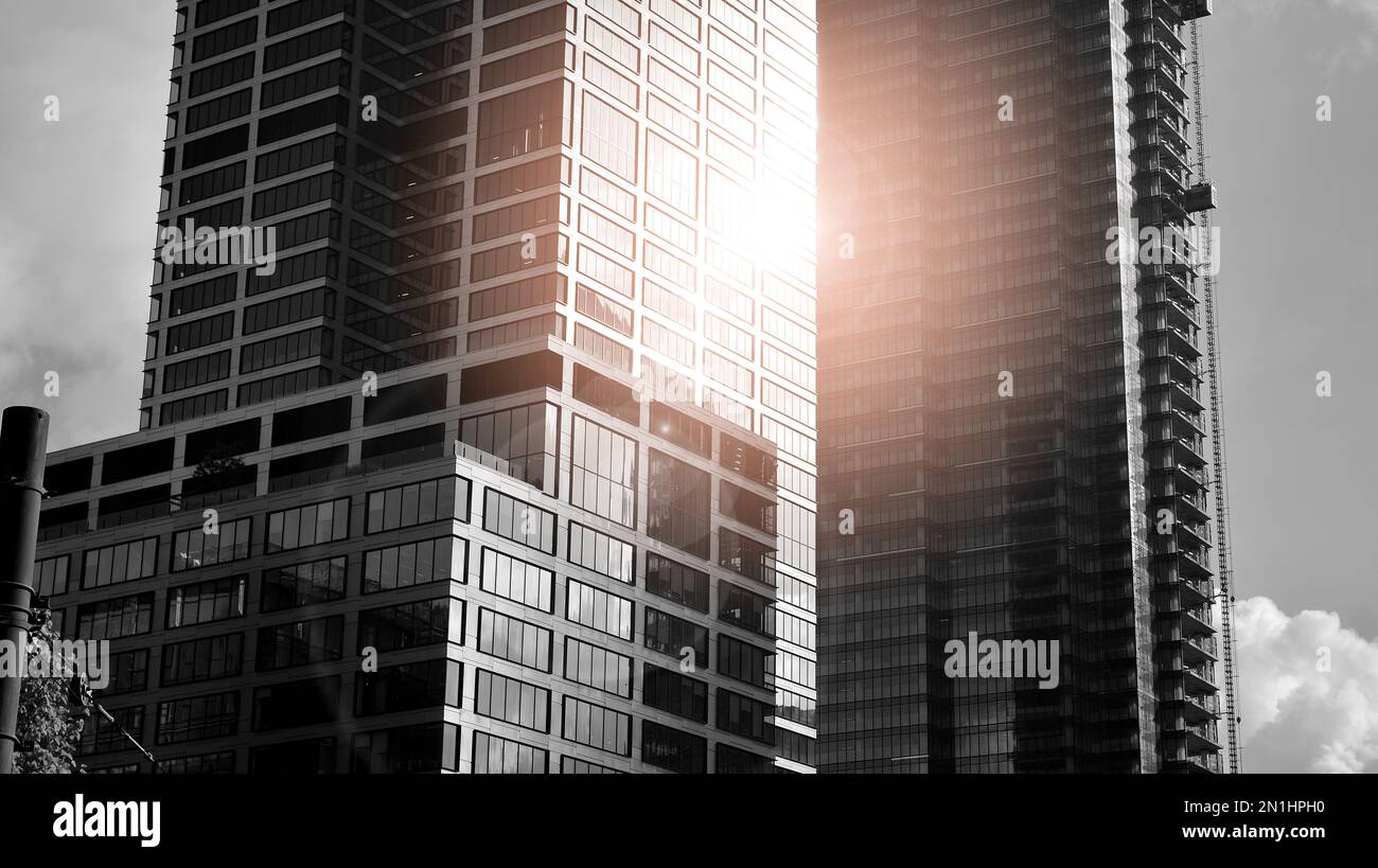 Bottom view of modern skyscraper in business district against blue sky ...